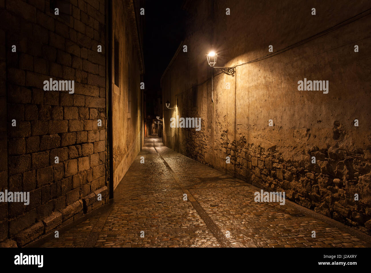 Street lamps illuminated cobbled narrow strret at night in old city of ...