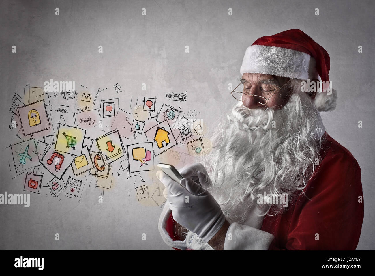 Santa Claus with phone and icons Stock Photo - Alamy