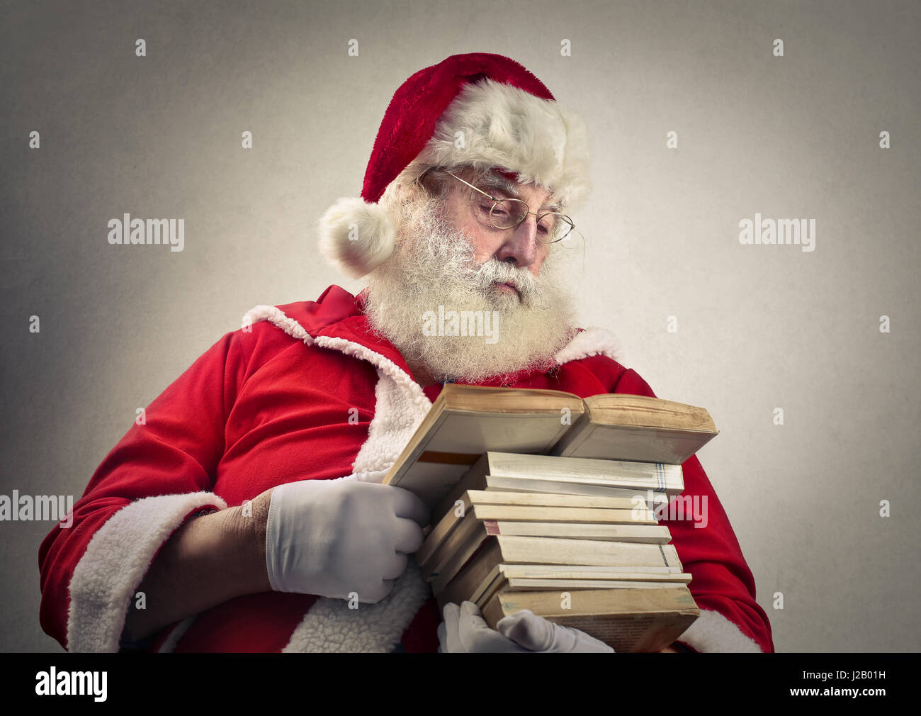 Santa Claus with books Stock Photo - Alamy