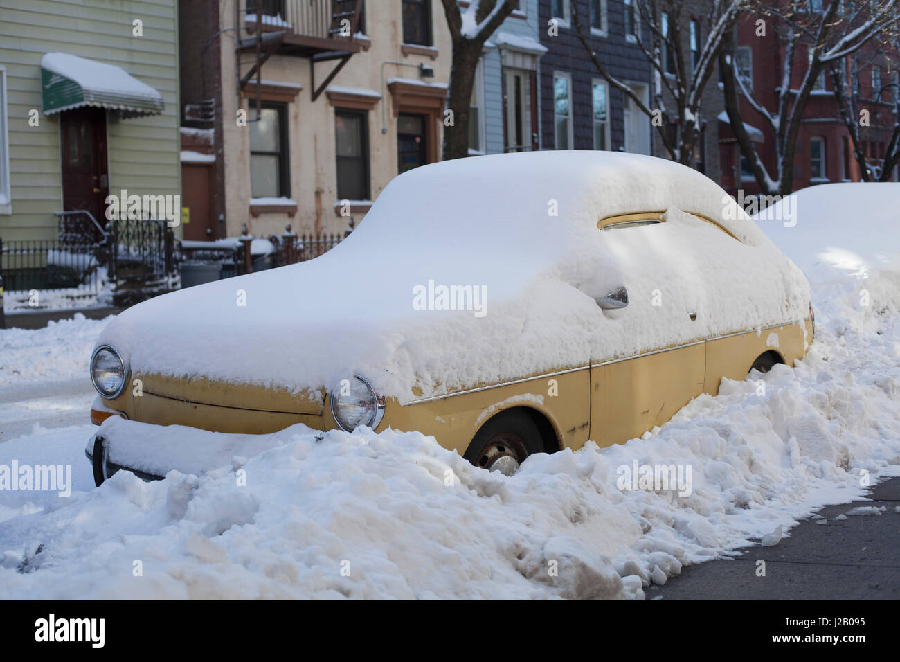 Snow covered car on street in city Stock Photo - Alamy