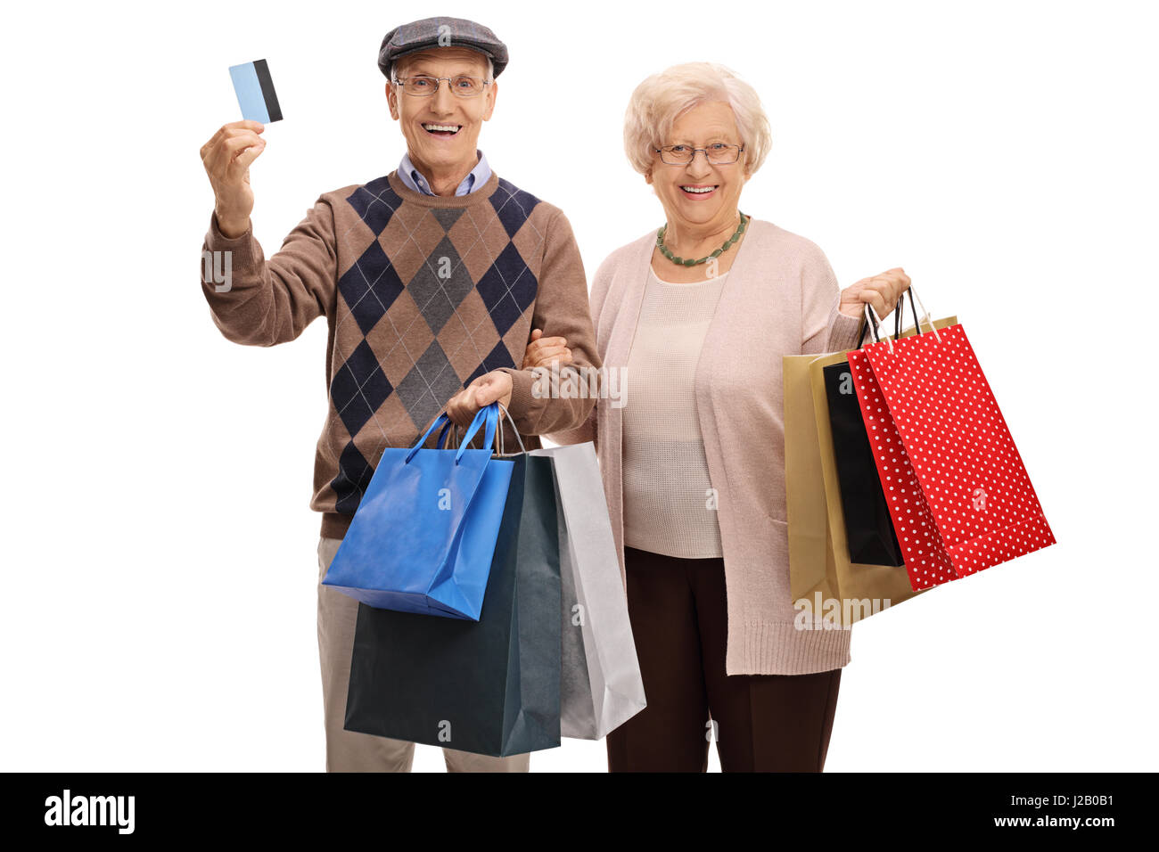 Cheerful seniors with a credit card and shopping bags isolated on white ...