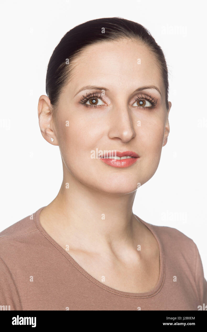 Beautiful thoughtful woman smiling against white background Stock Photo ...