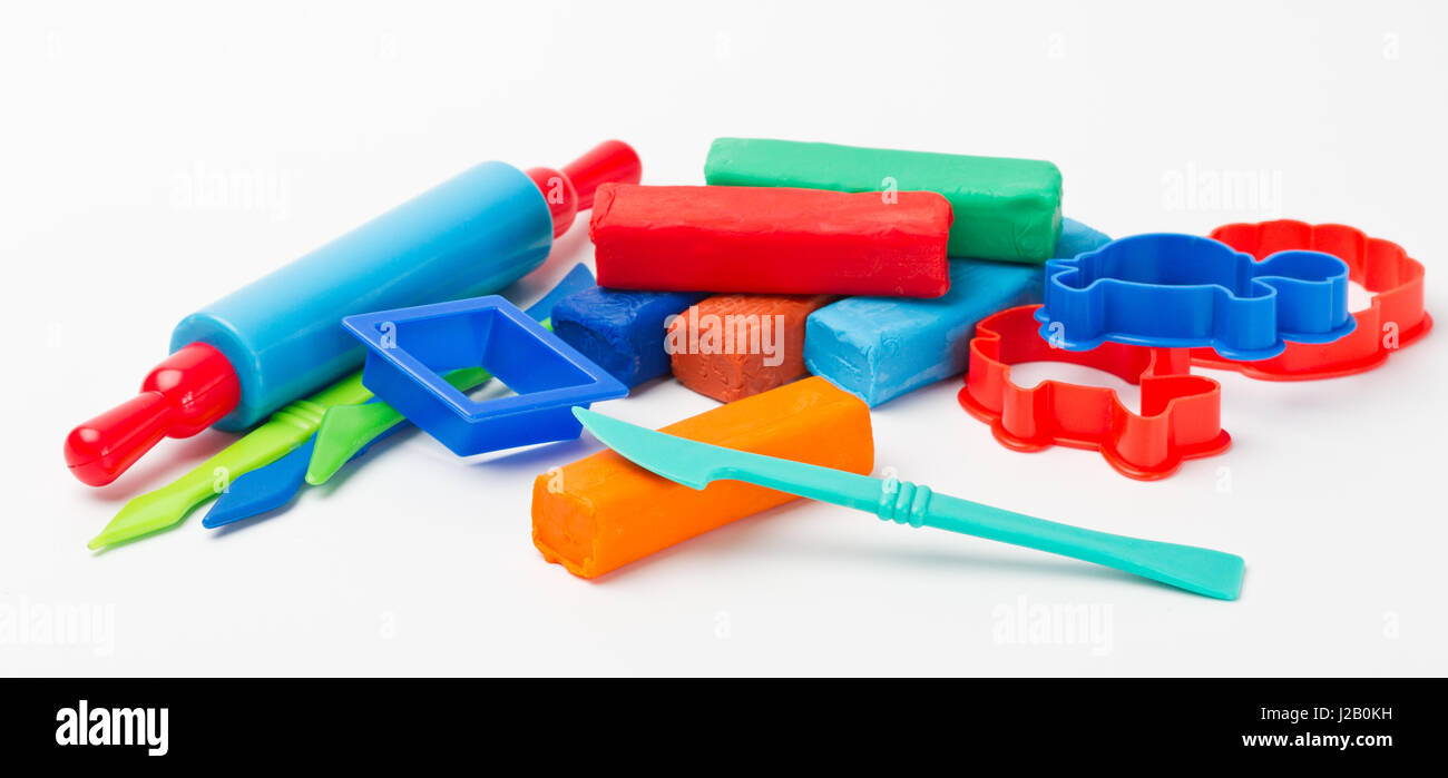 Colorful plasticine and tools on white background Stock Photo - Alamy