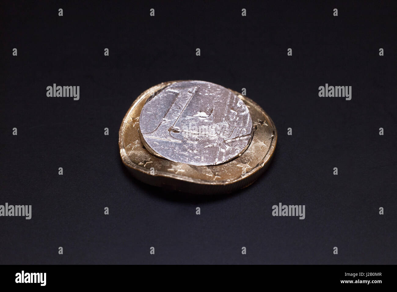 Close-up of dented one Euro coin against black background Stock Photo ...