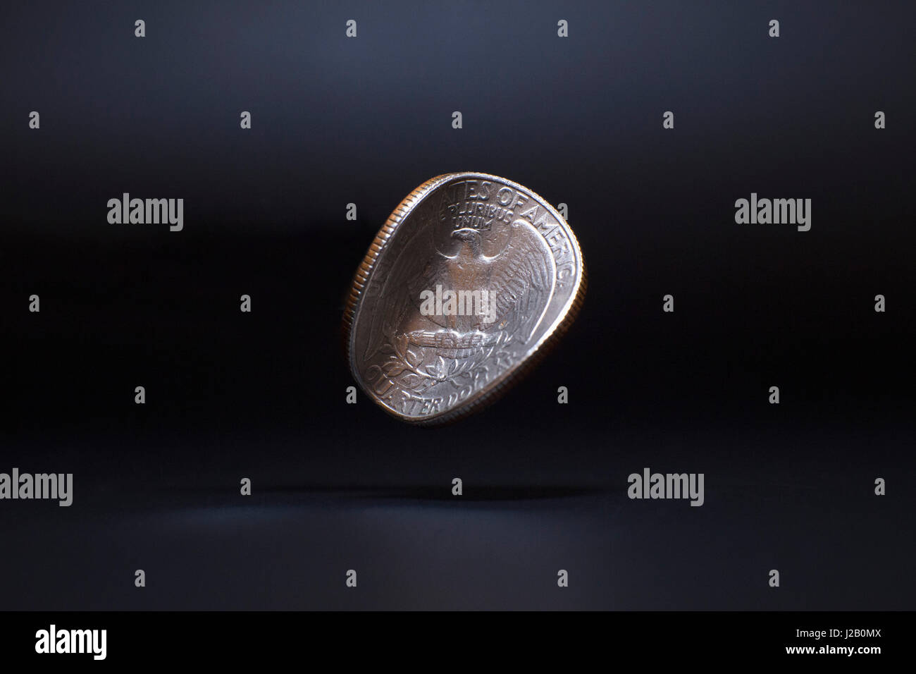 Close-up of damaged Washington quarter dollar levitating against black ...