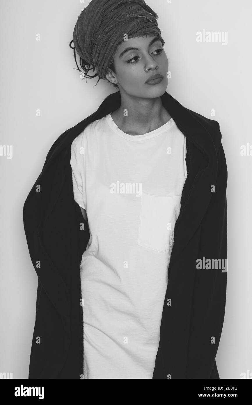 Beautiful fashion model wearing headscarf and jacket against wall Stock ...