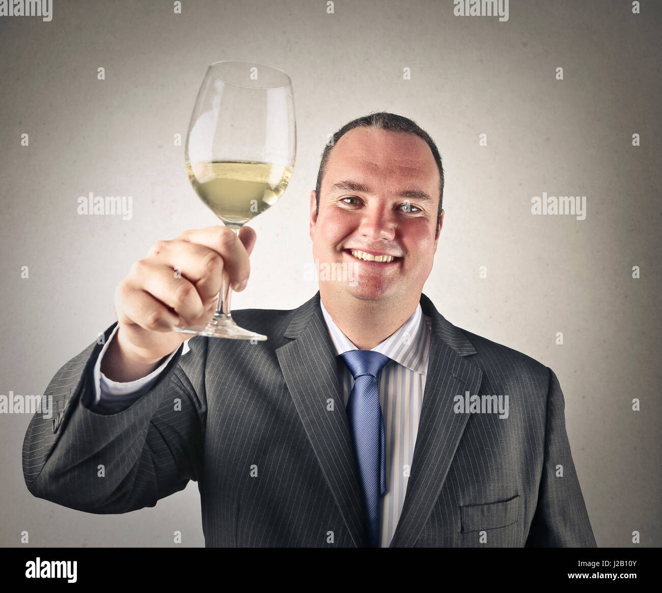 Fat businessman with glass of champagne Stock Photo - Alamy