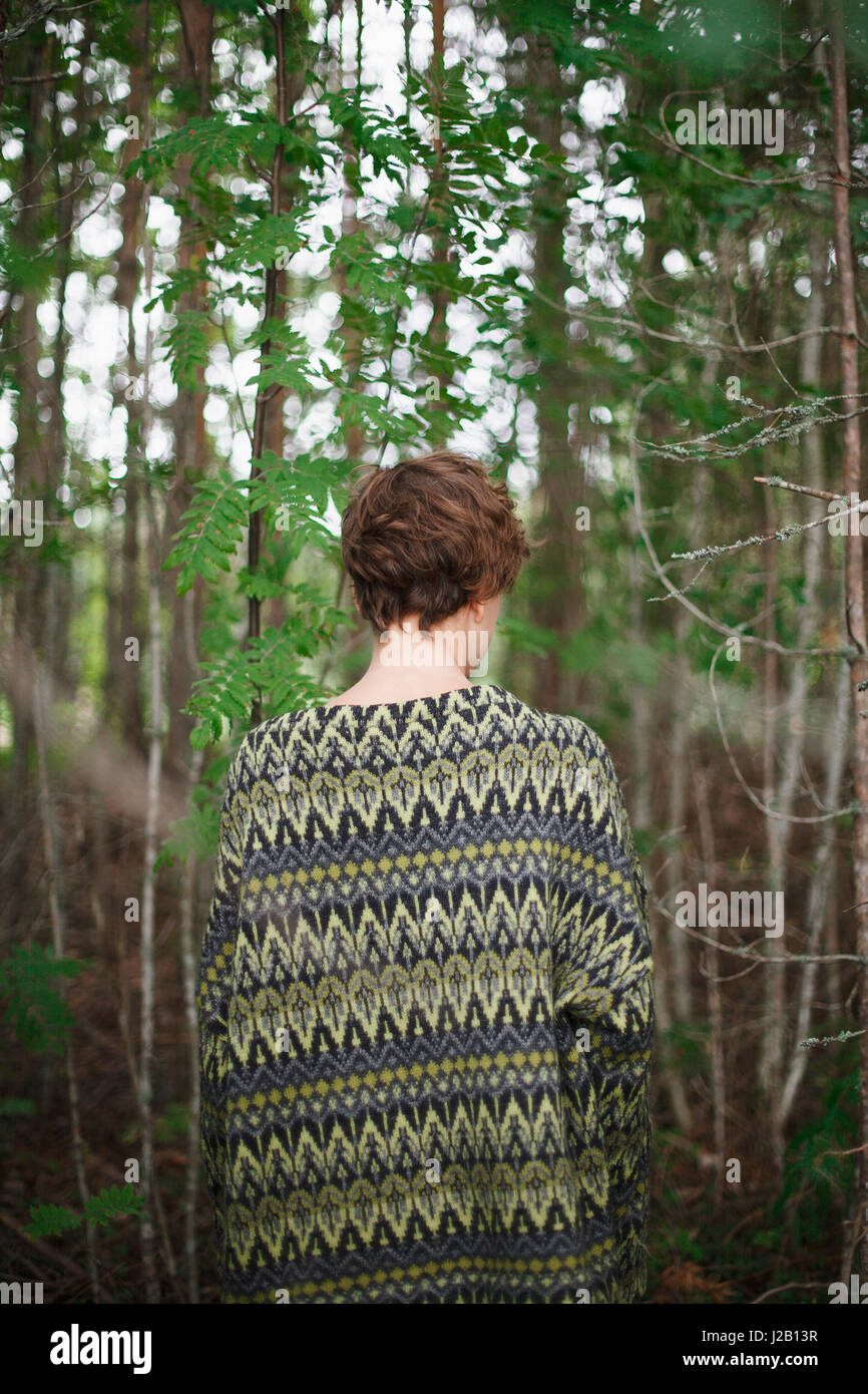 Rear view of woman standing in forest Stock Photo - Alamy