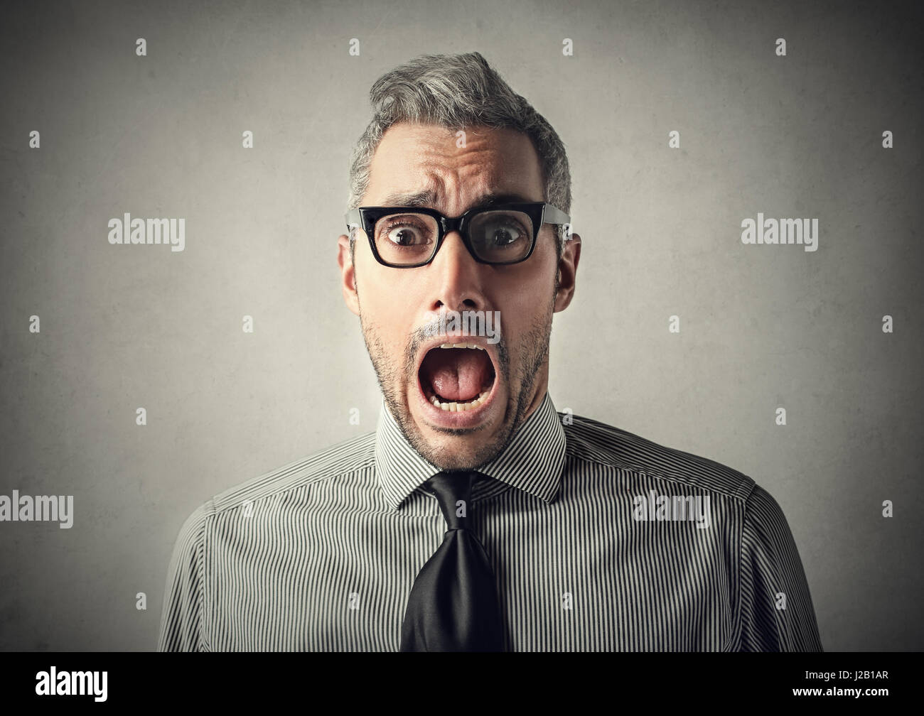 Businessman making scared face Stock Photo - Alamy