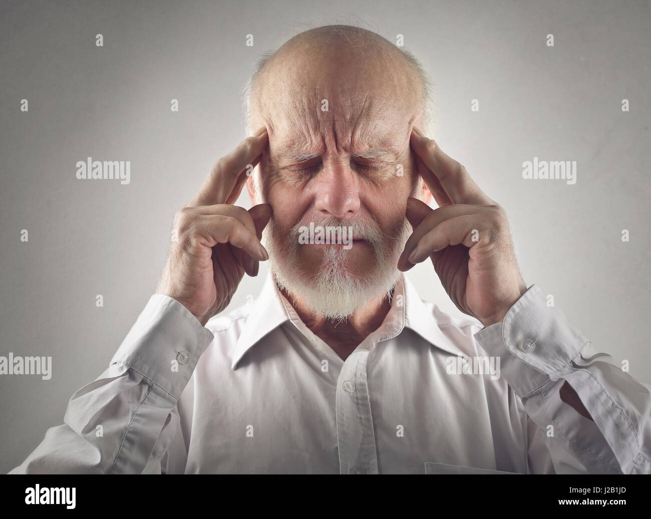Old man with headache Stock Photo - Alamy