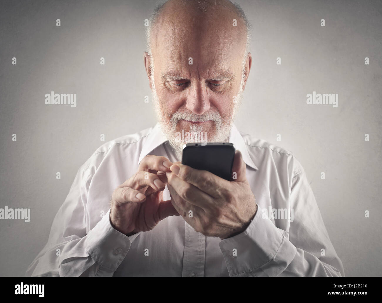 Old man using mobile phone Stock Photo - Alamy