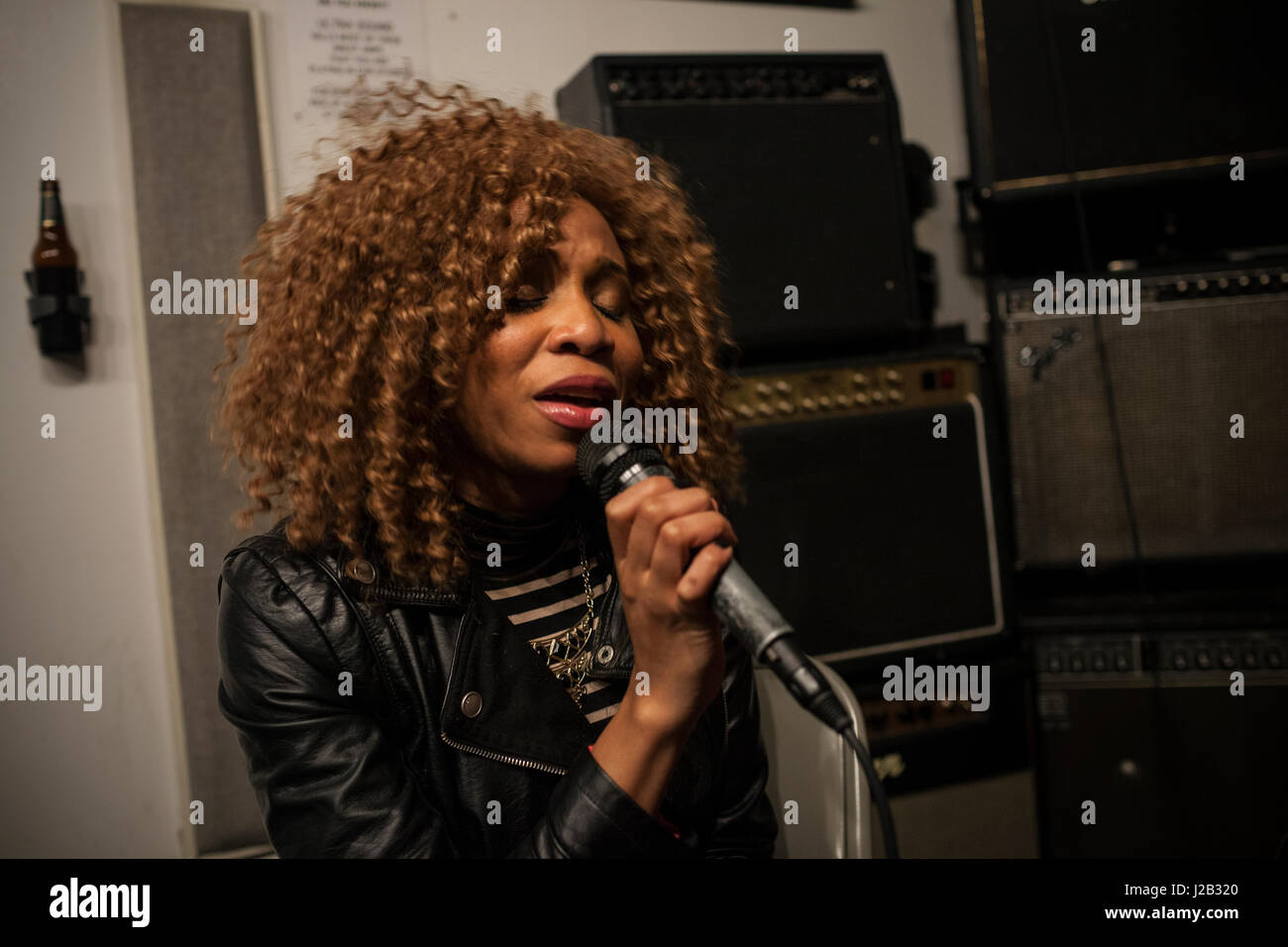 Woman singing in a recording studio Stock Photo - Alamy