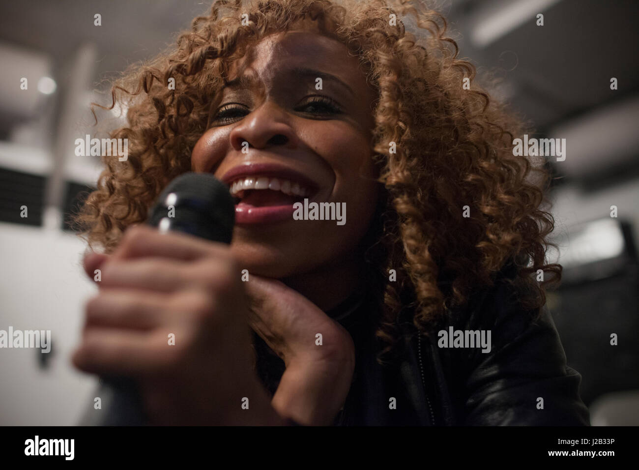 Singer performing in a recording studio Stock Photo - Alamy