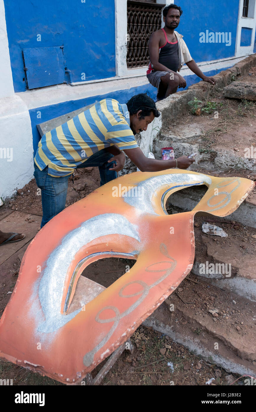A painter decorates one of the masks for the carnival parade Stock ...