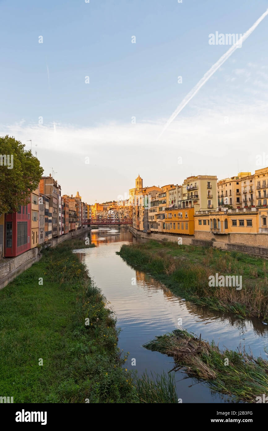 Onyar river crossing the downtown of Girona with bell tower of Basilica ...