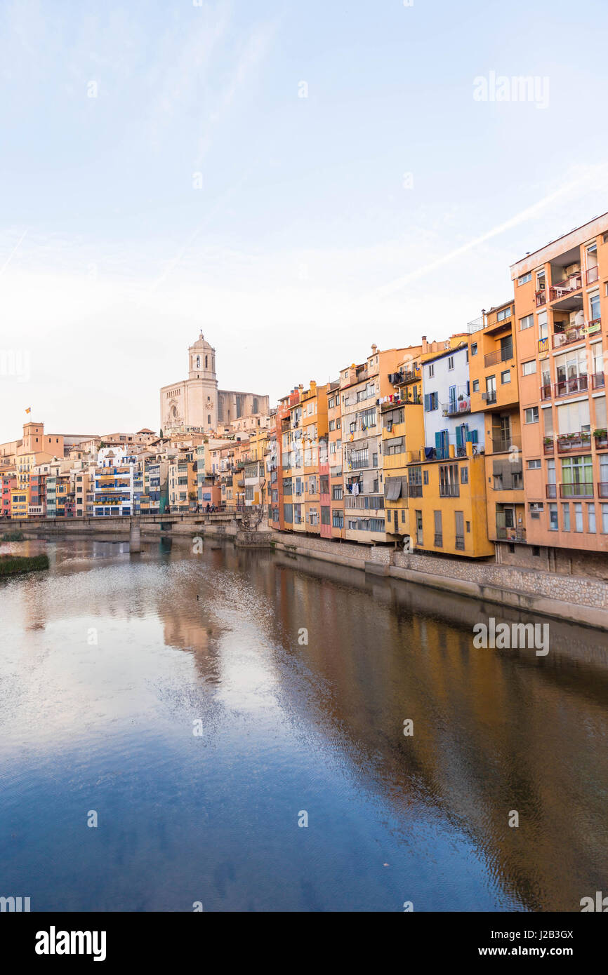 Onyar river crossing the downtown of Girona with bell tower of Basilica ...