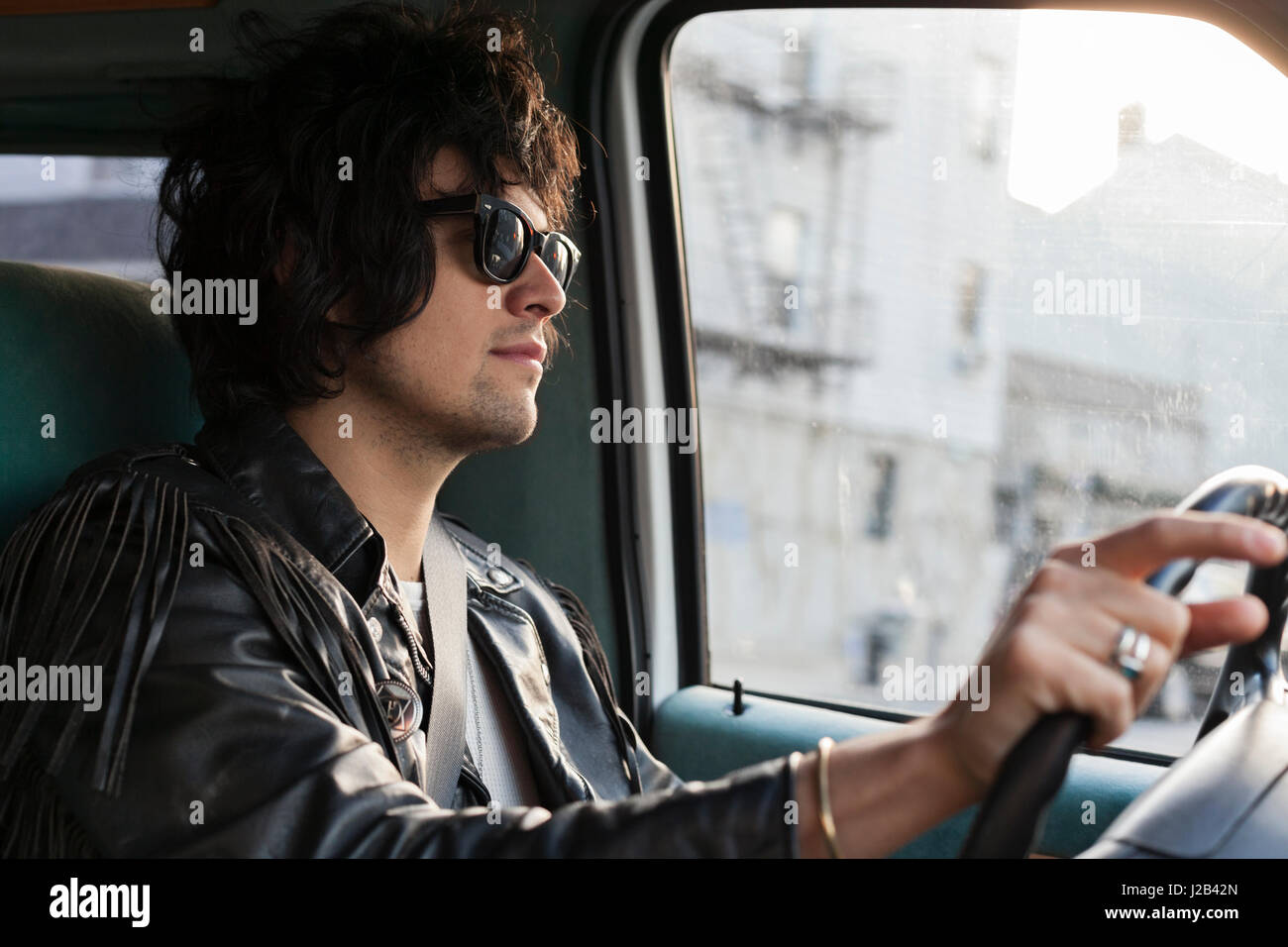 Young man driving Stock Photo - Alamy