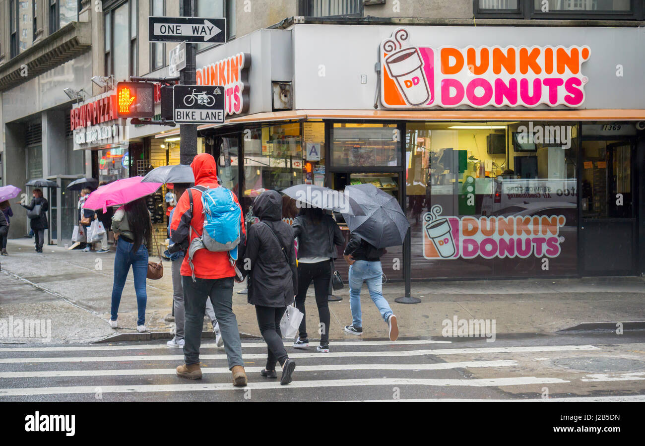 A Dunkin' Donuts franchise in the rain in Midtown Manhattan in New York ...