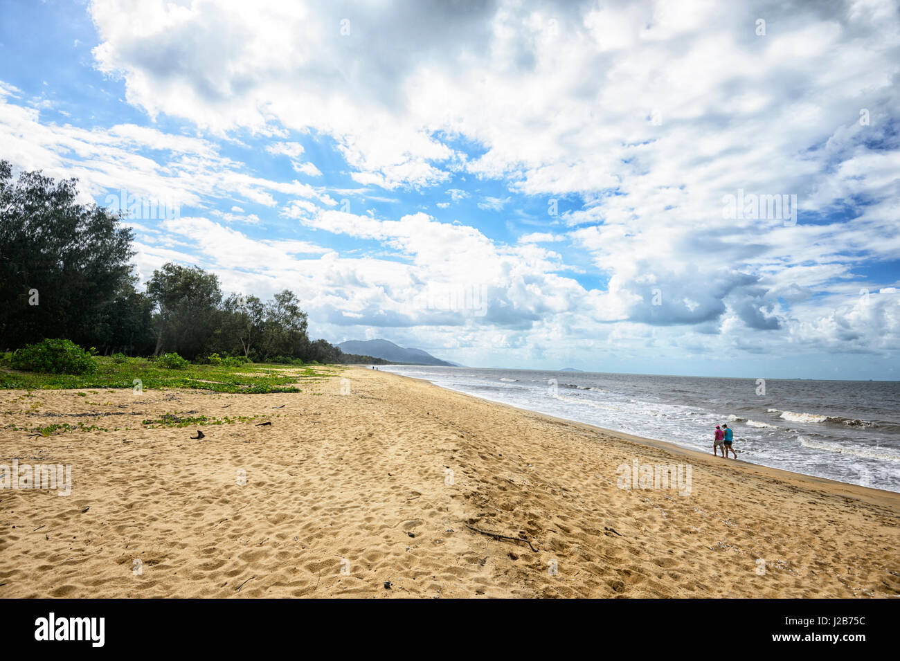 Two persons walking on the beach at Bramston Beach, Far North ...