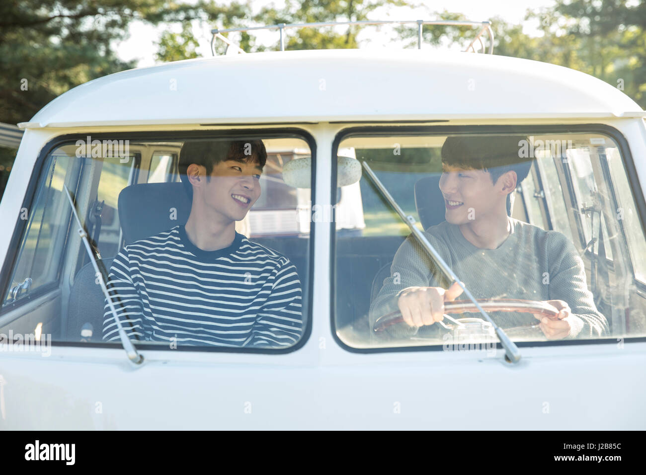 Two young men in a camping car Stock Photo - Alamy