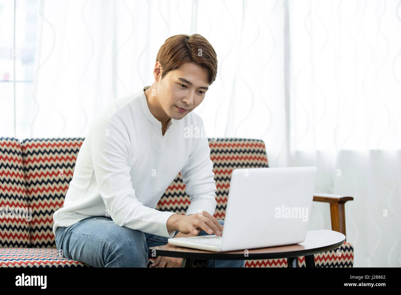 Man using a laptop Stock Photo - Alamy