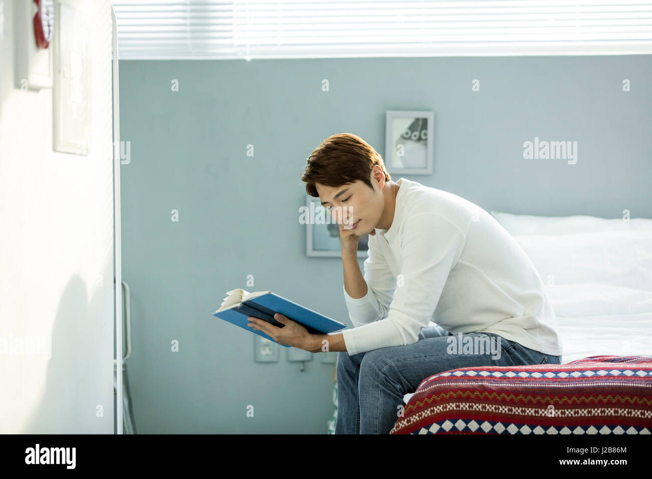 Man resting reading a book Stock Photo - Alamy