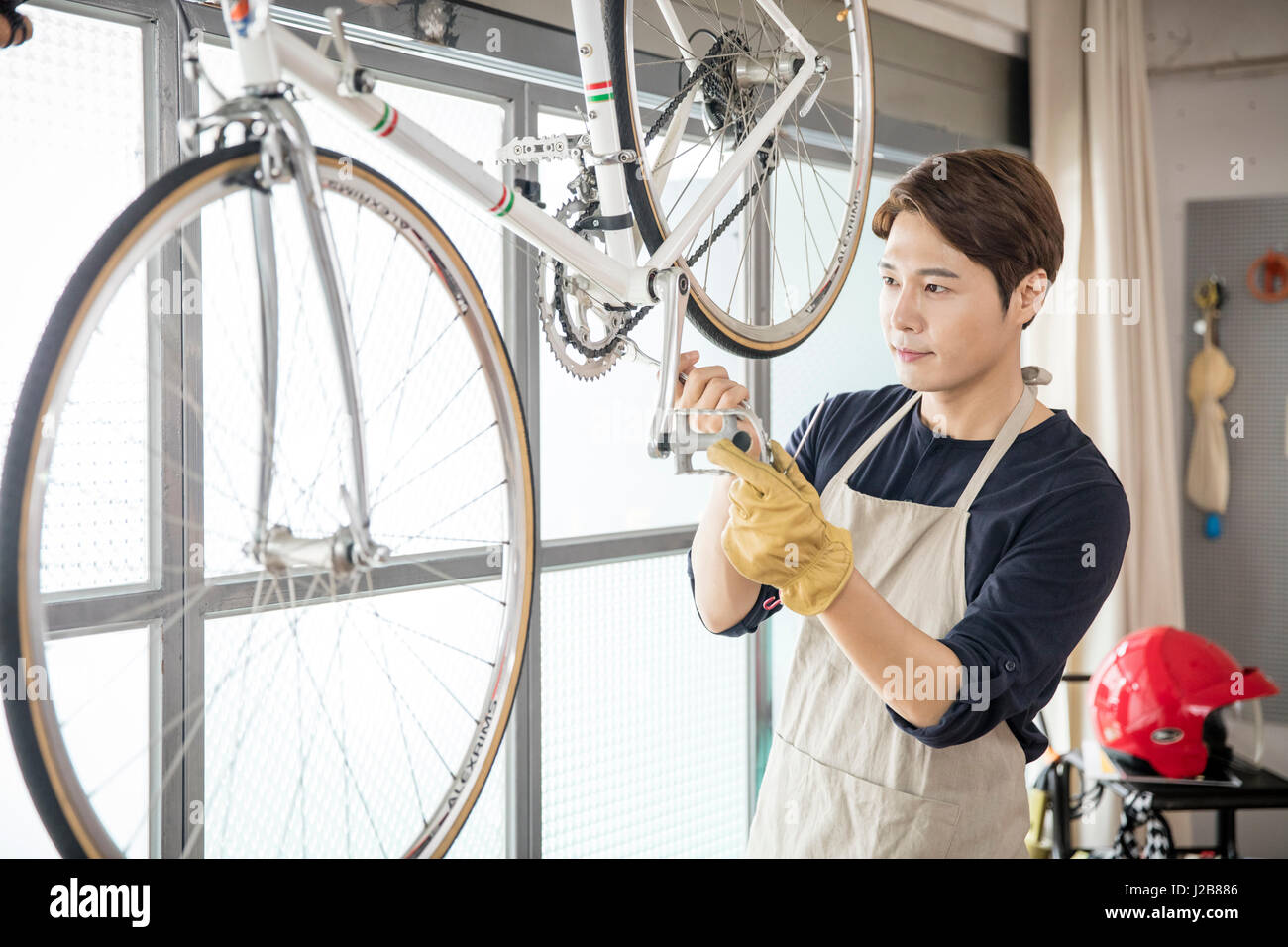 Man fixing a bicycle Stock Photo - Alamy