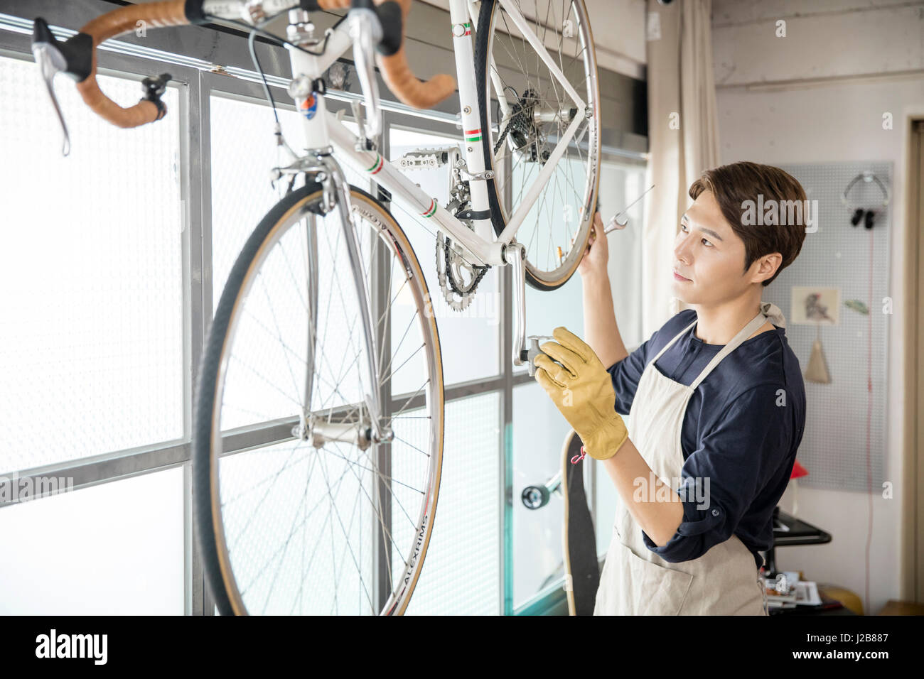 Man fixing a bicycle Stock Photo - Alamy