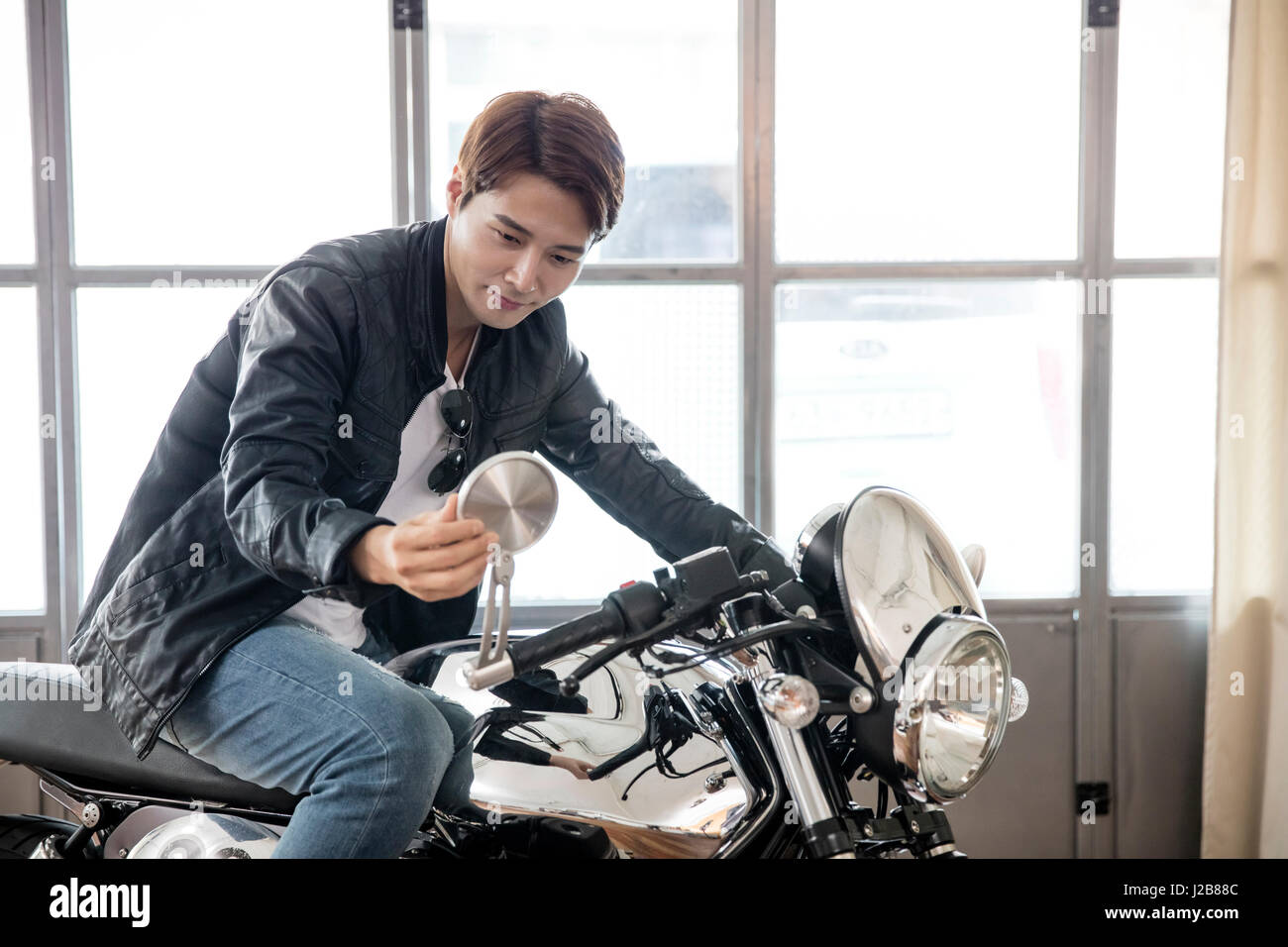Man sitting on a motorcycle Stock Photo - Alamy