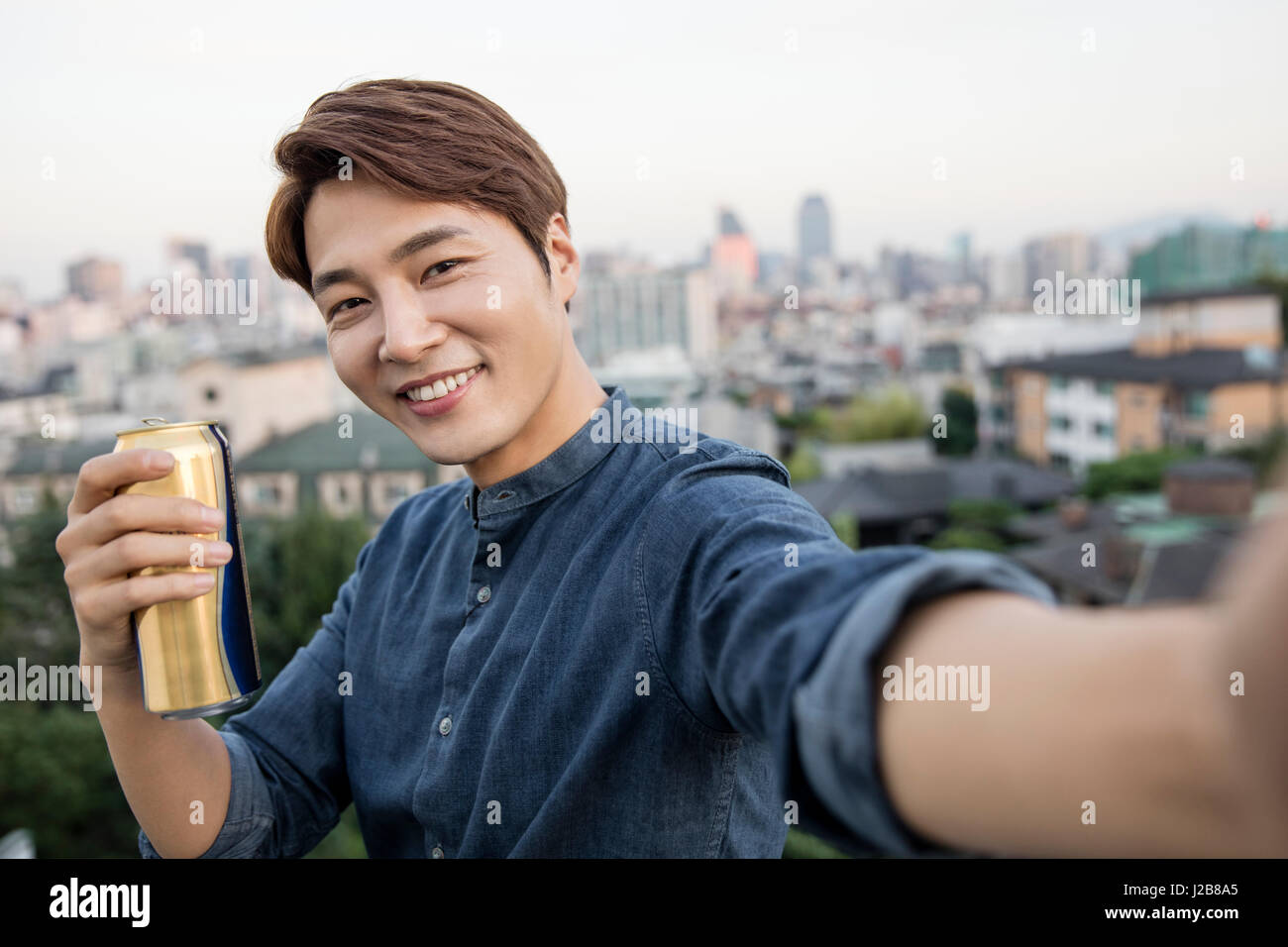 Smiling man with beer can Stock Photo - Alamy