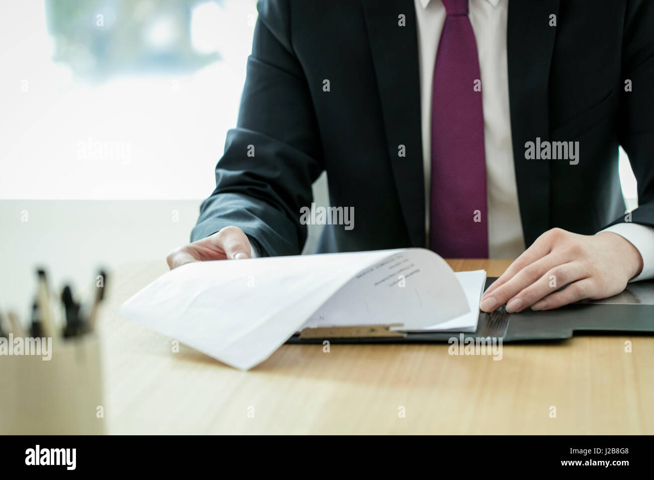 Businessman signing a paper Stock Photo - Alamy