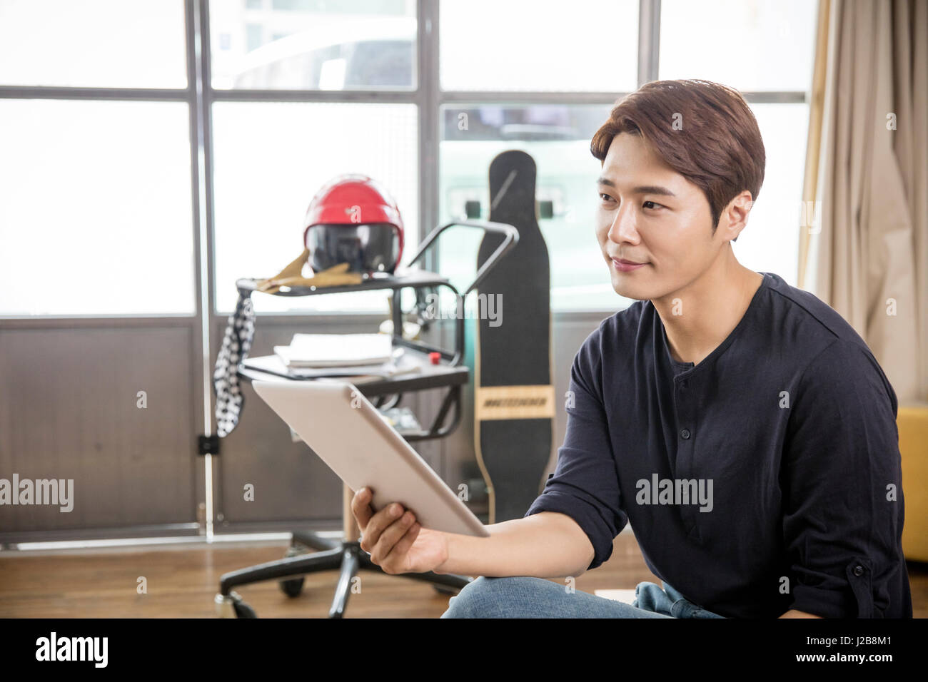 Smiling man with tablet at workroom Stock Photo - Alamy