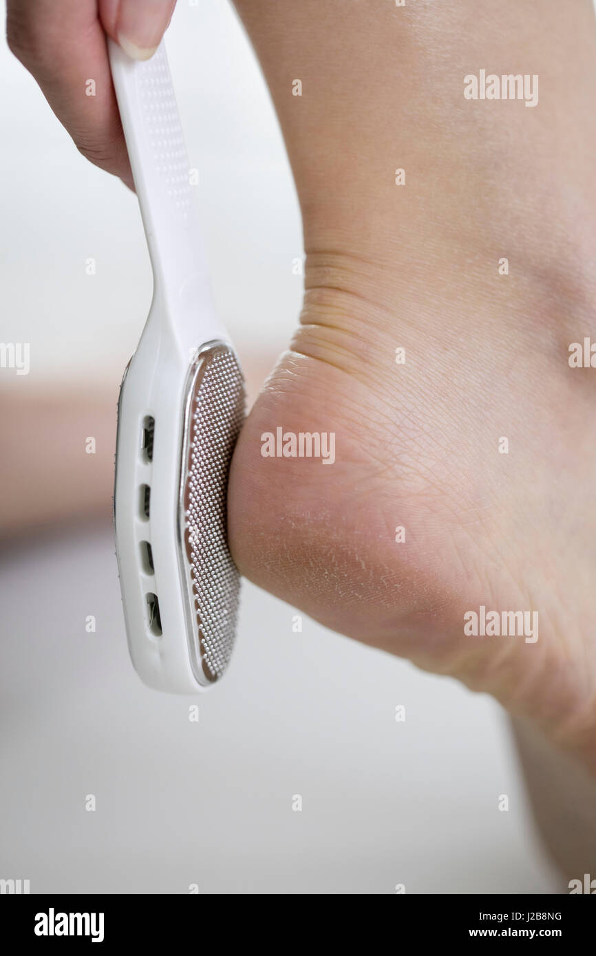 Removing callus from heels Stock Photo - Alamy