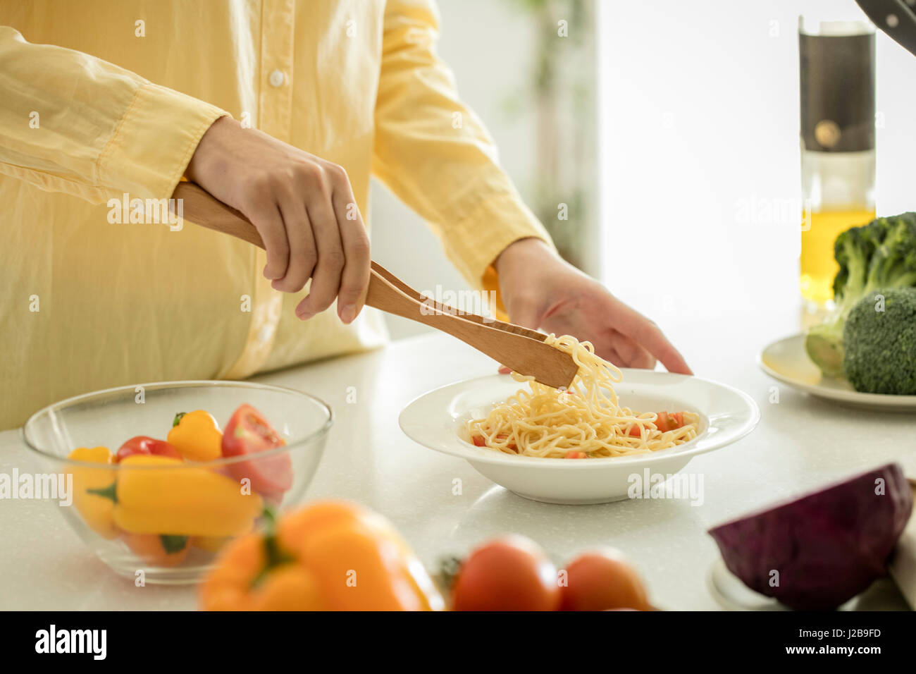 Woman cooking spaghetti Stock Photo - Alamy