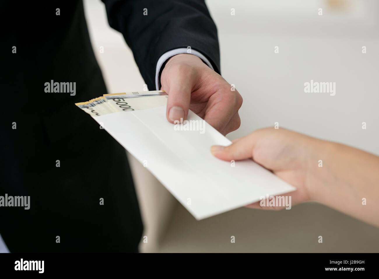 Businessman passing envelope with bills Stock Photo - Alamy