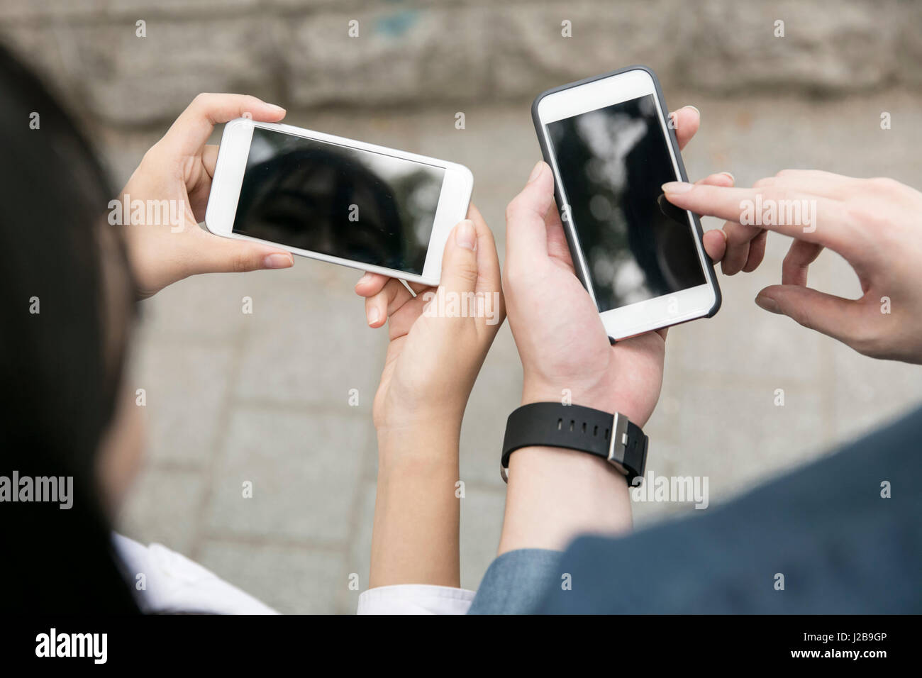 Young people using smartphones Stock Photo - Alamy
