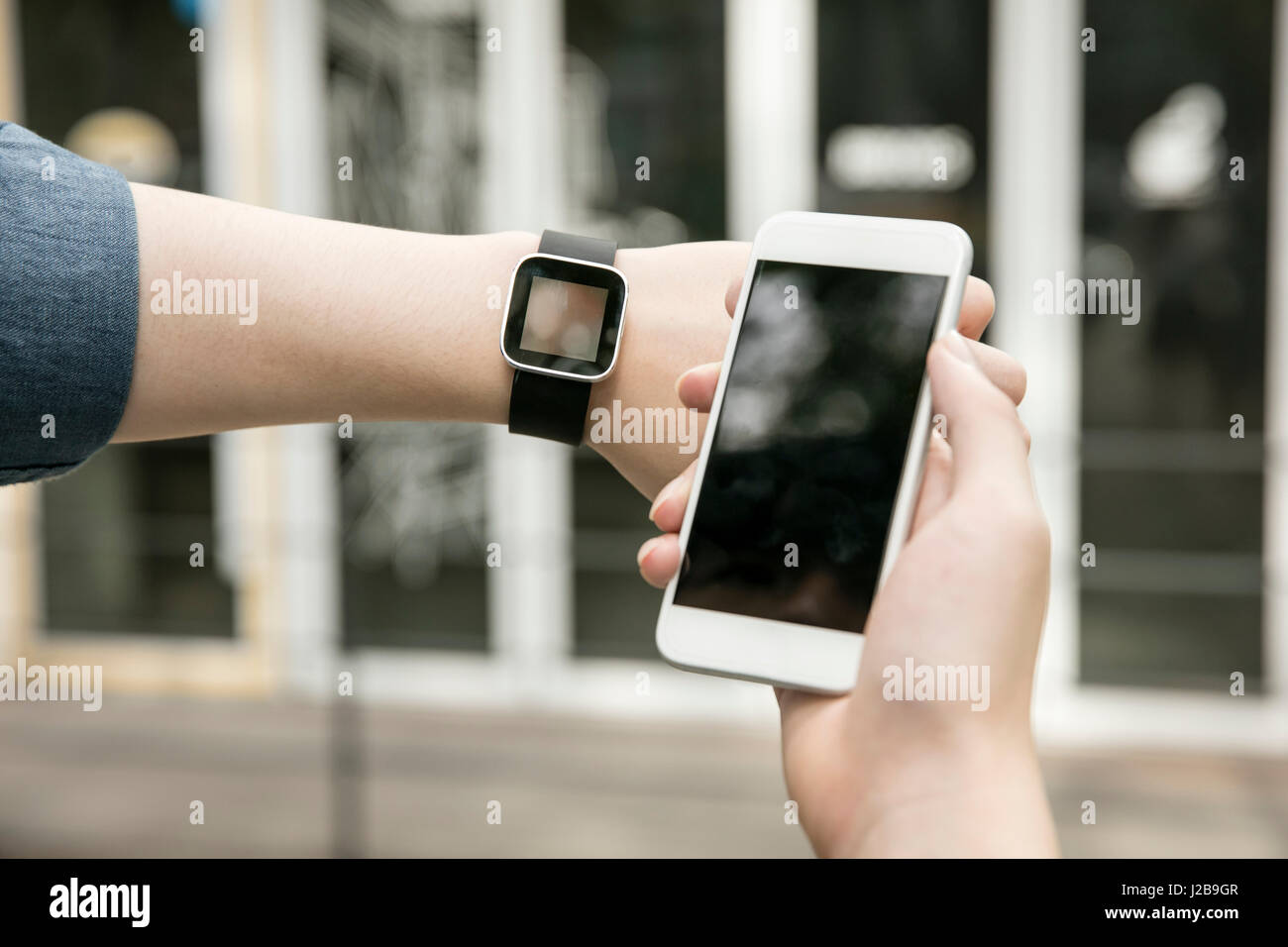 Hands with smartphone and smartwatch Stock Photo - Alamy