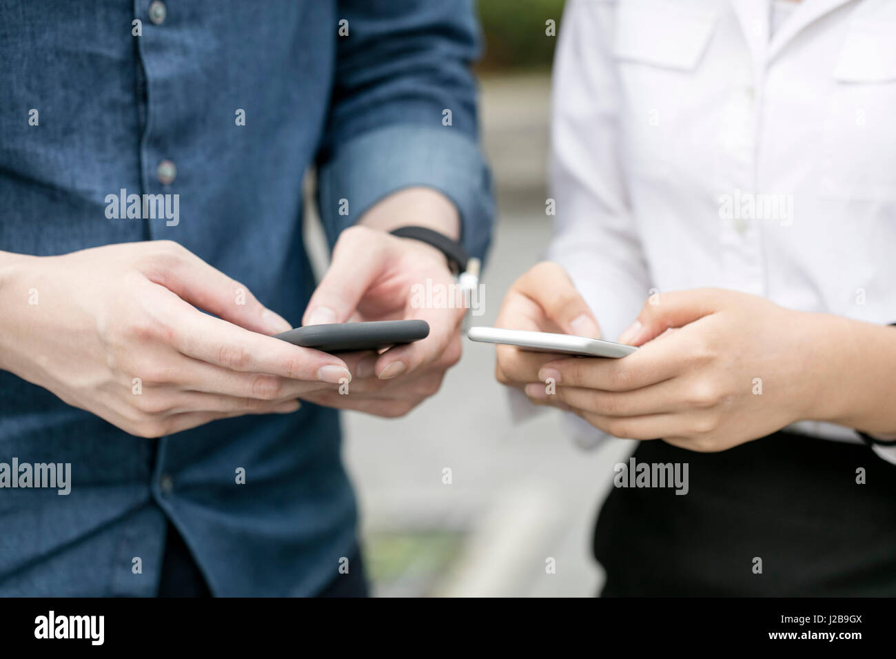 Young people using smartphones Stock Photo - Alamy