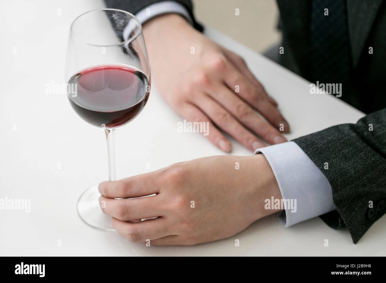 Businessman with red wine Stock Photo - Alamy