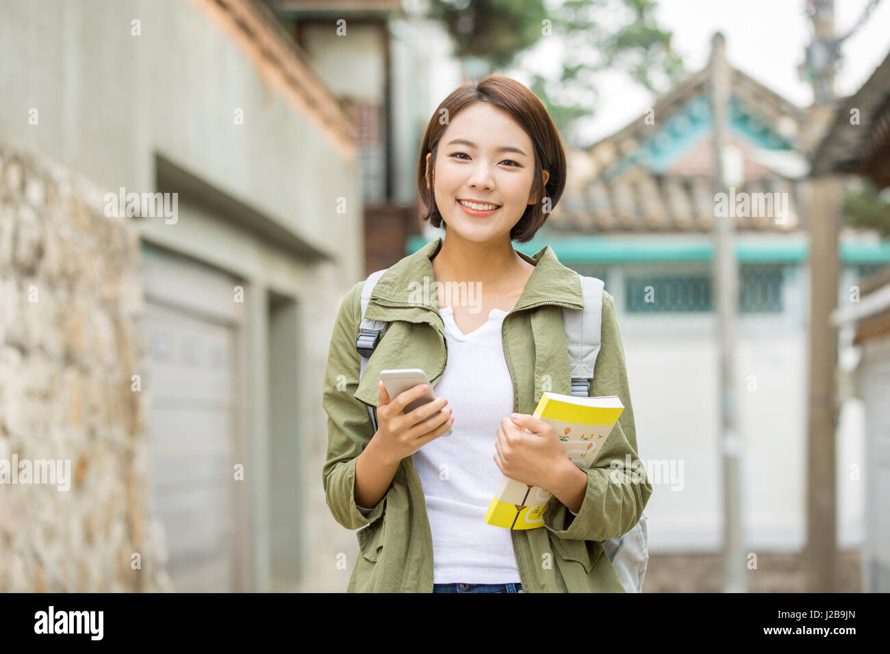 Young smiling female tourist Stock Photo - Alamy