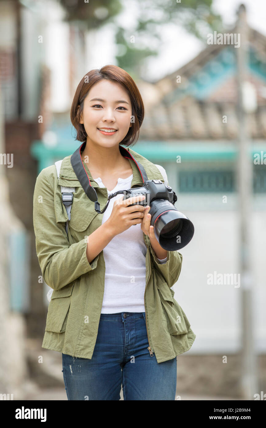 Young smiling female tourist Stock Photo - Alamy