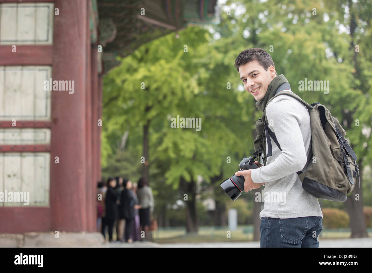 Young smiling male tourist Stock Photo - Alamy
