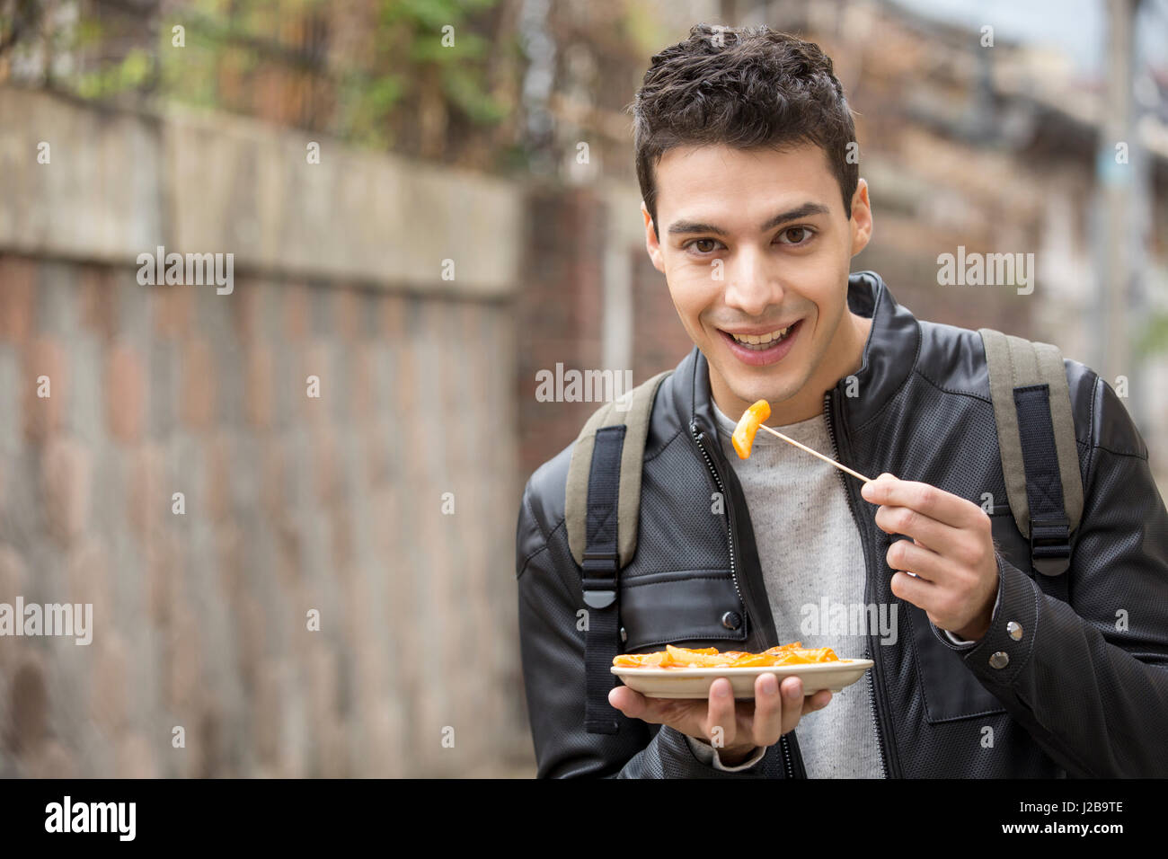 Portrait of young smiling male tourist Stock Photo - Alamy