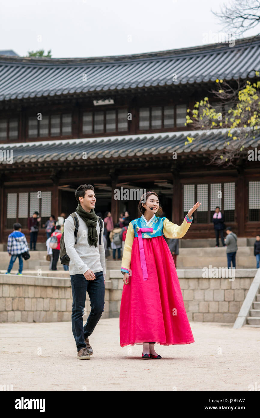 Foreign tourist and Korean female tour guide at Korean palace Stock ...