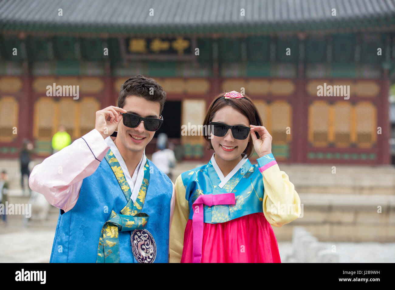 Portrait of young smiling couple in Korean clothes Stock Photo - Alamy