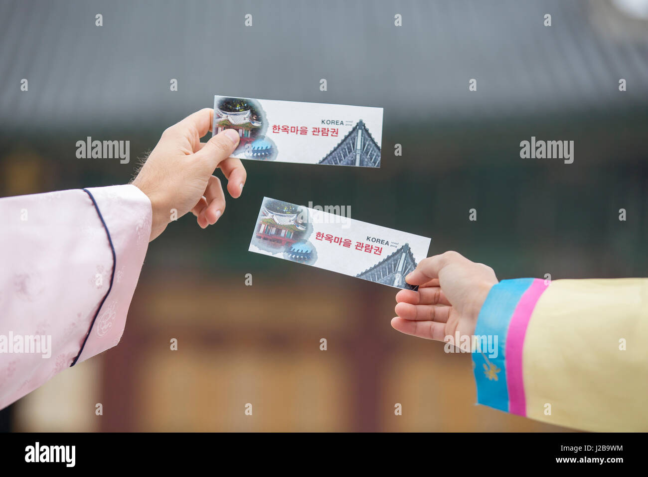 Couple in traditional Korean clothes with tickets Stock Photo - Alamy