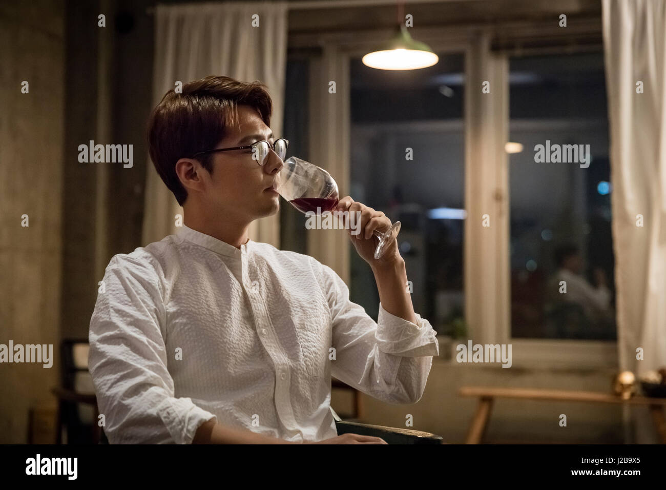 Portrait of man drinking wine Stock Photo - Alamy