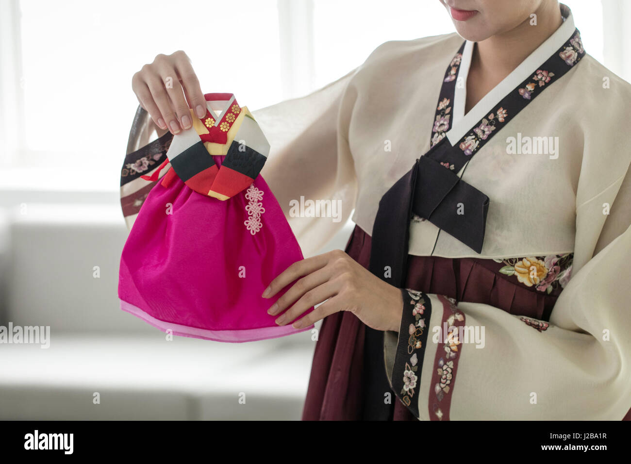 Korean woman with miniature of hanbok Stock Photo - Alamy