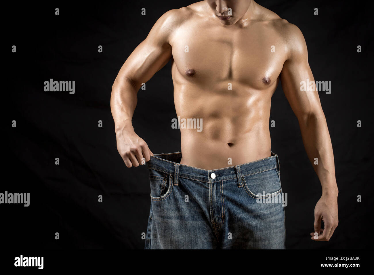 Healthy muscular man succeeding in diet Stock Photo - Alamy