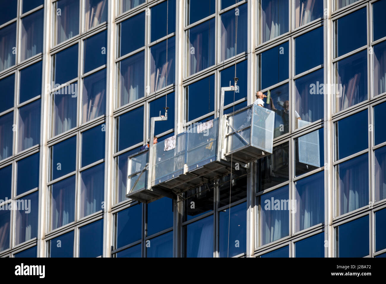Berlin, Germany, window cleaner at the facade of a skyscraper at ...